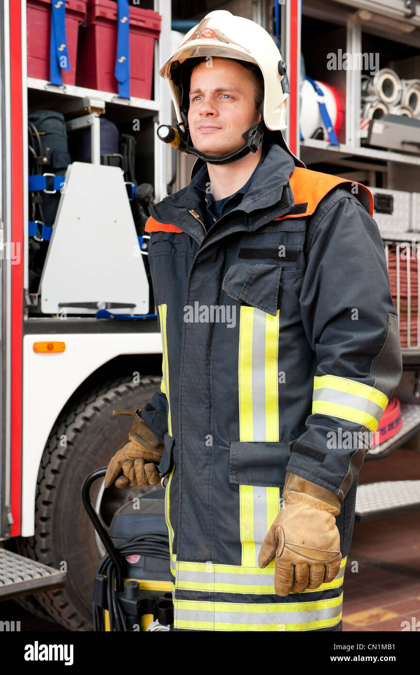 Picture from a young and successful firefighter at work Stock Photo - Alamy