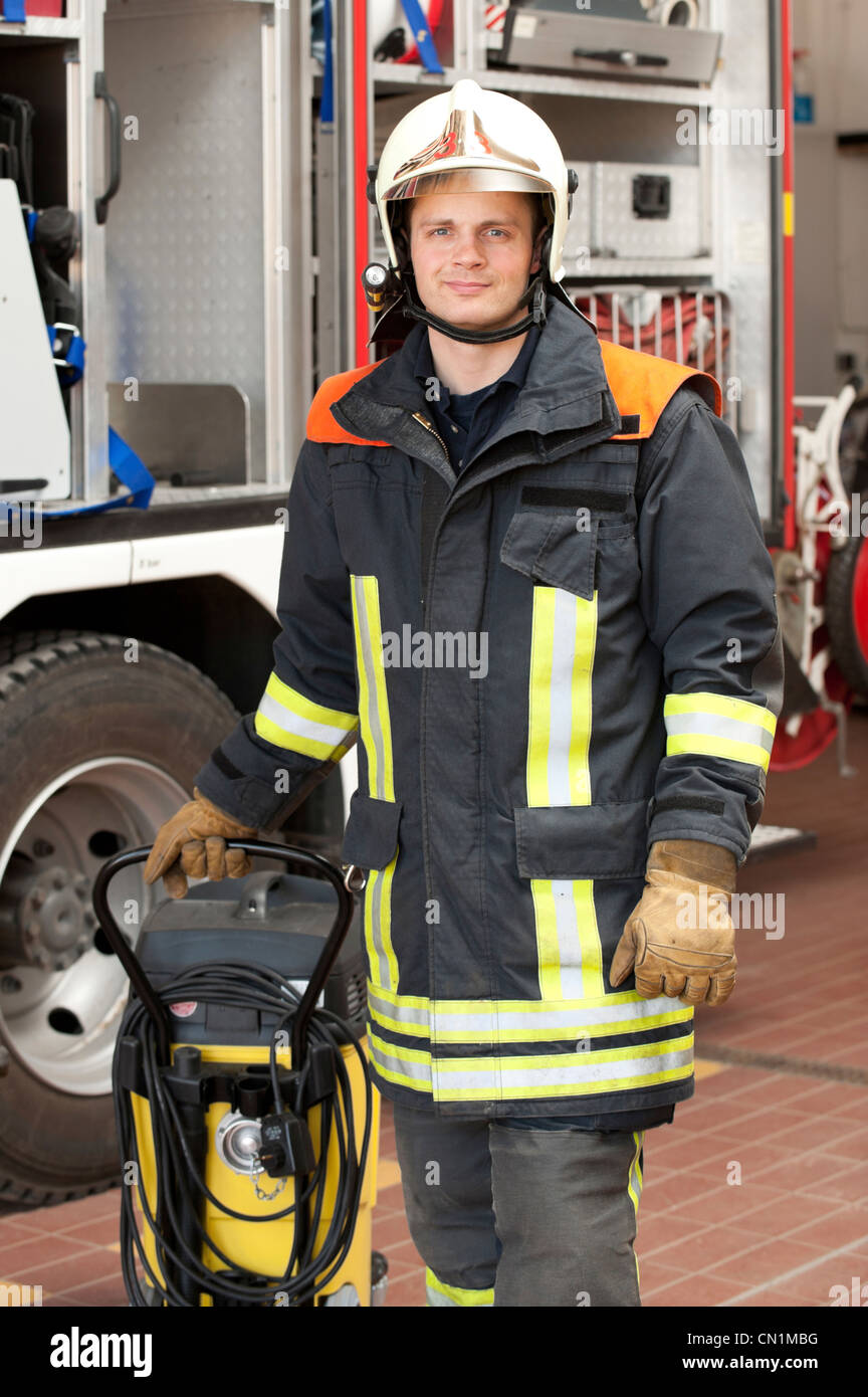 Picture from a young and successful firefighter at work Stock Photo - Alamy