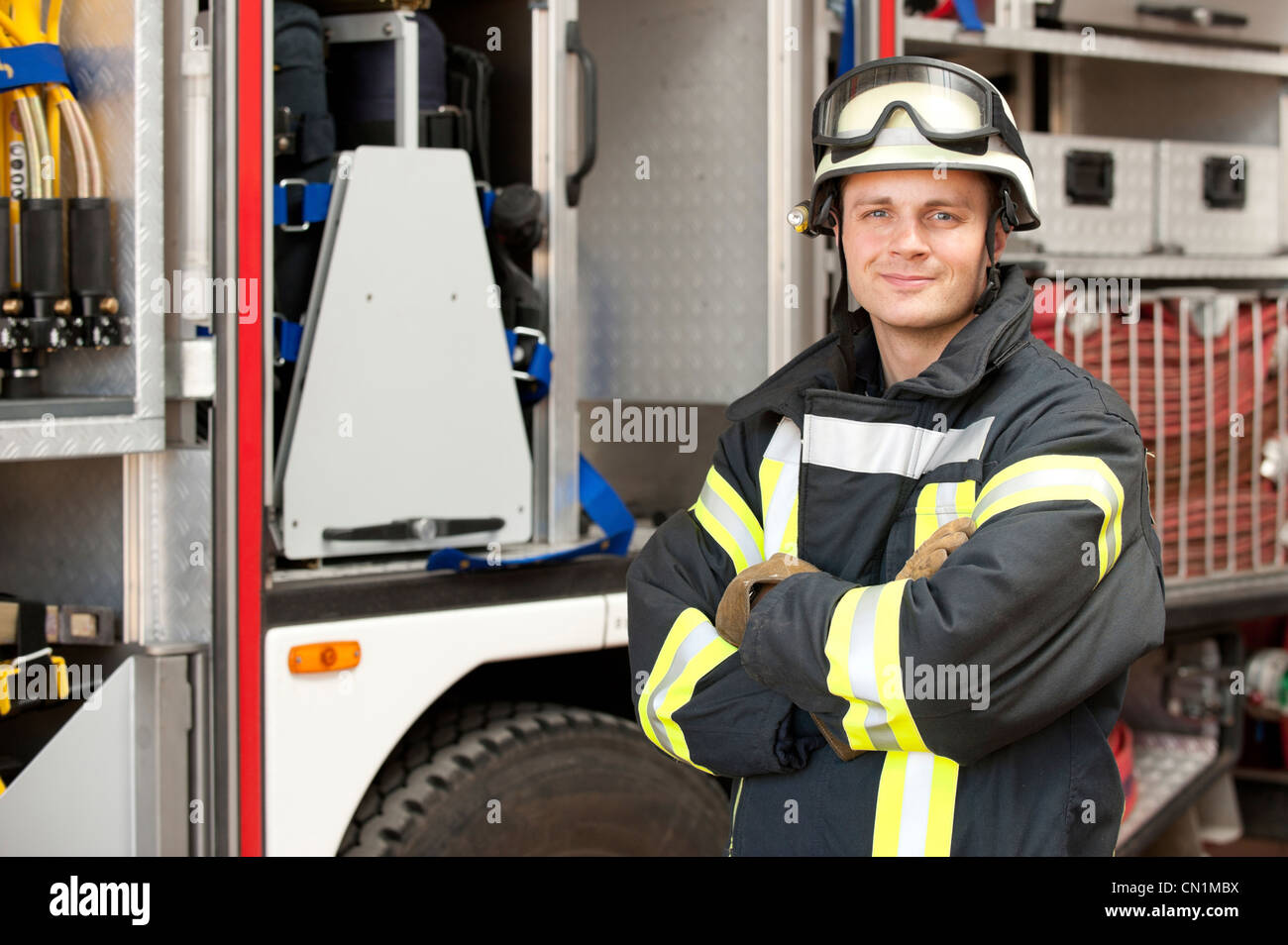 Picture from a young and successful firefighter at work Stock Photo - Alamy