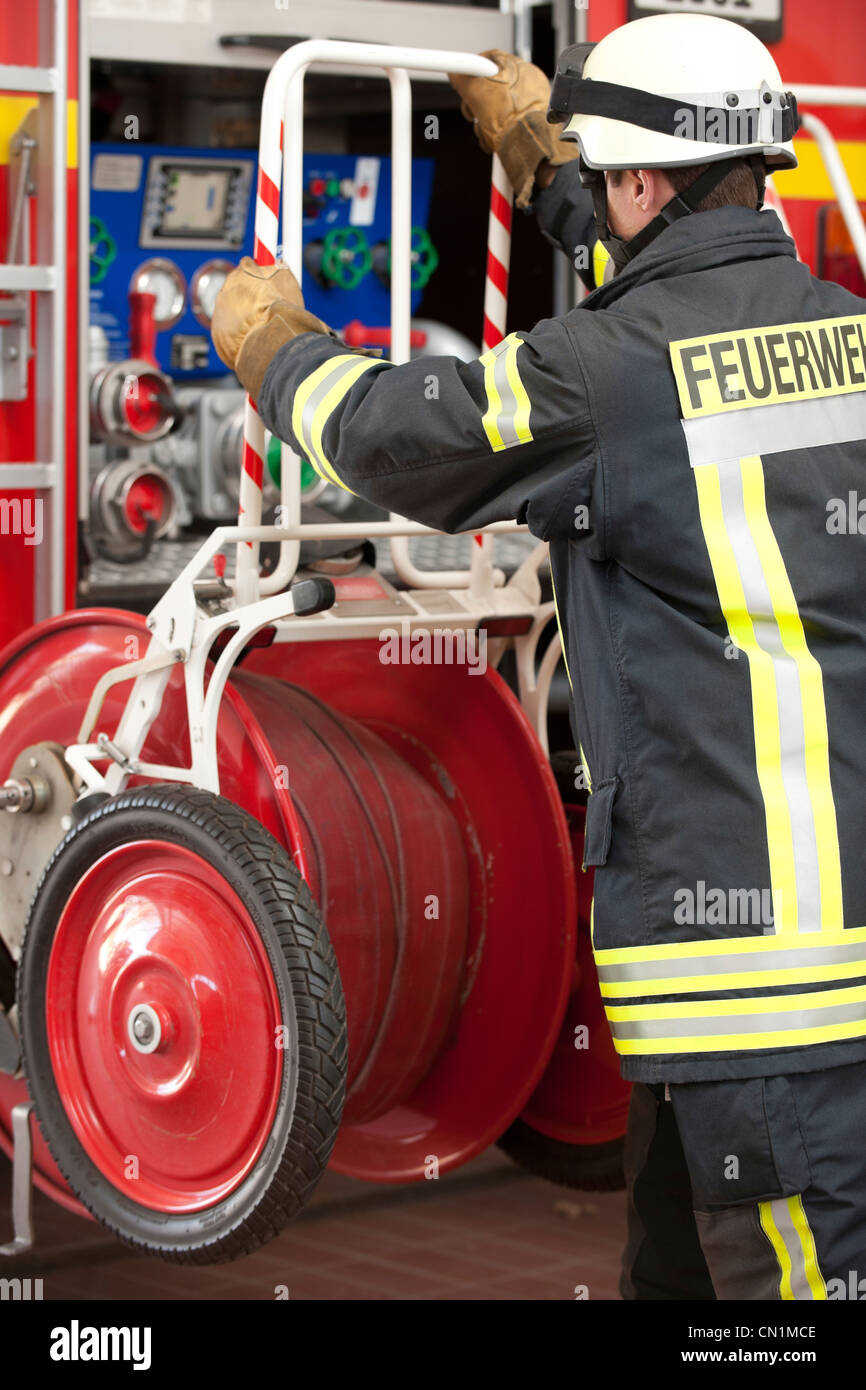 Picture from a young and successful firefighter at work Stock Photo - Alamy