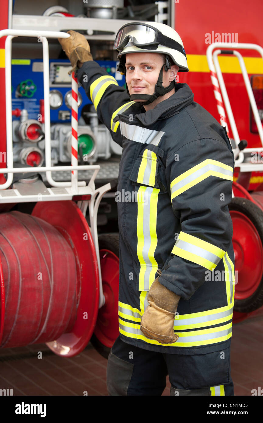 Picture from a young and successful firefighter at work Stock Photo - Alamy