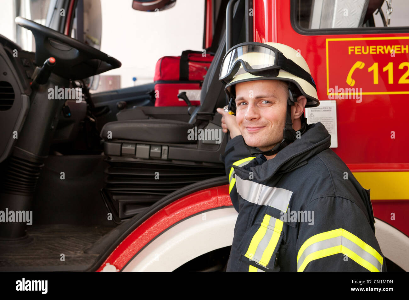 Picture from a young and successful firefighter at work Stock Photo - Alamy