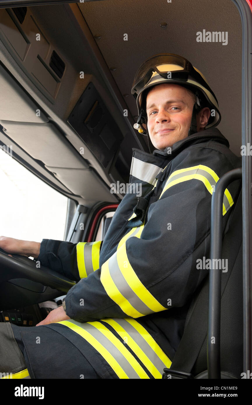 Picture from a young and successful firefighter at work Stock Photo - Alamy