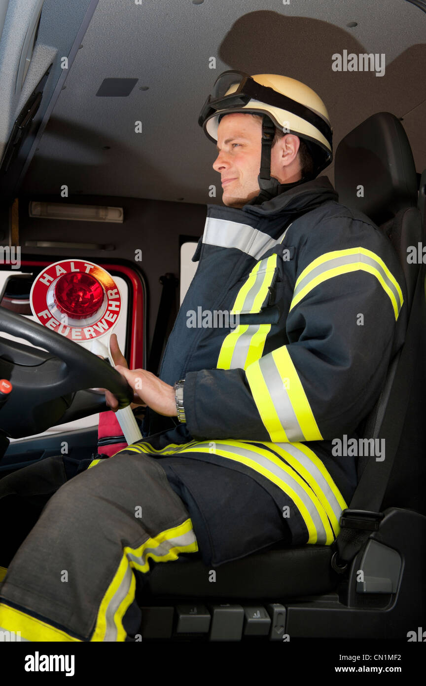 Picture from a young and successful firefighter at work Stock Photo - Alamy