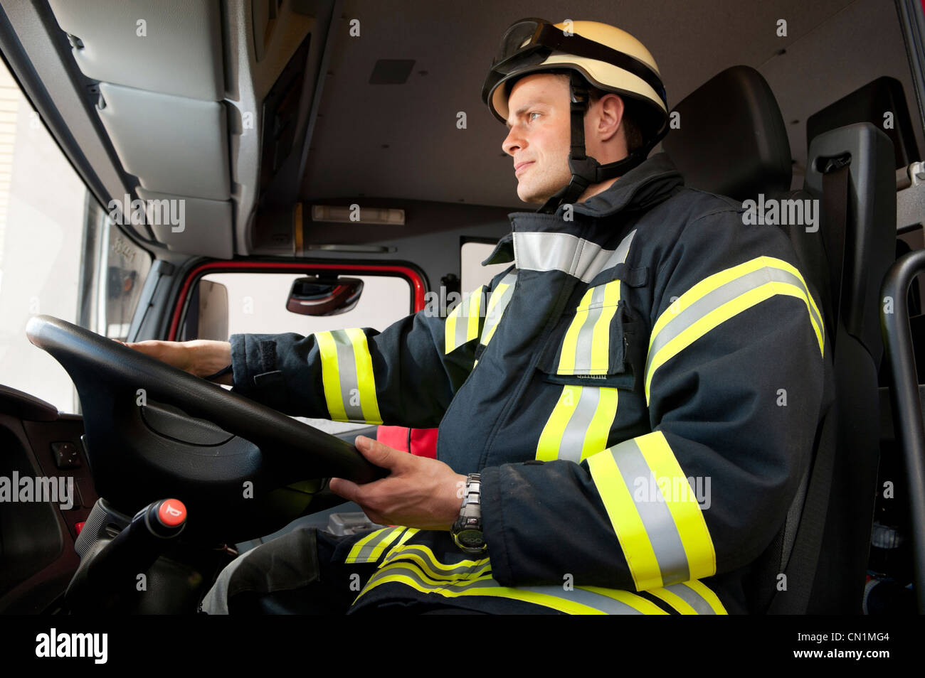 Picture from a young and successful firefighter at work Stock Photo - Alamy