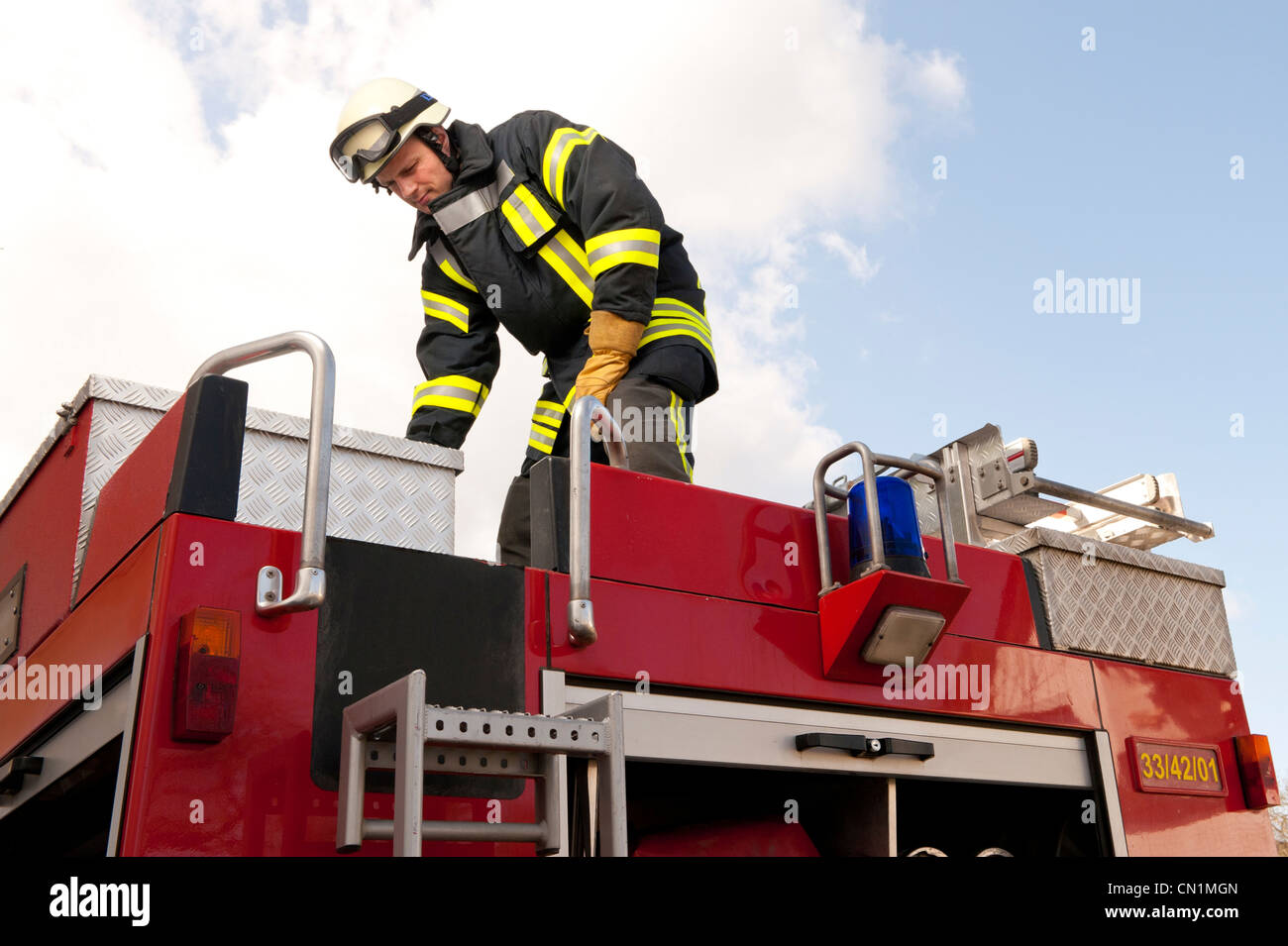 Picture from a young and successful firefighter at work Stock Photo - Alamy