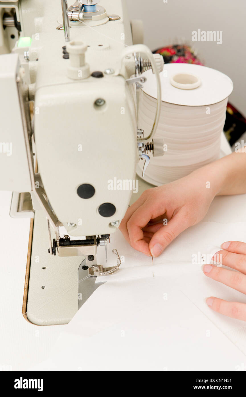 Dressmaker with sewing machine in her studio Stock Photo - Alamy