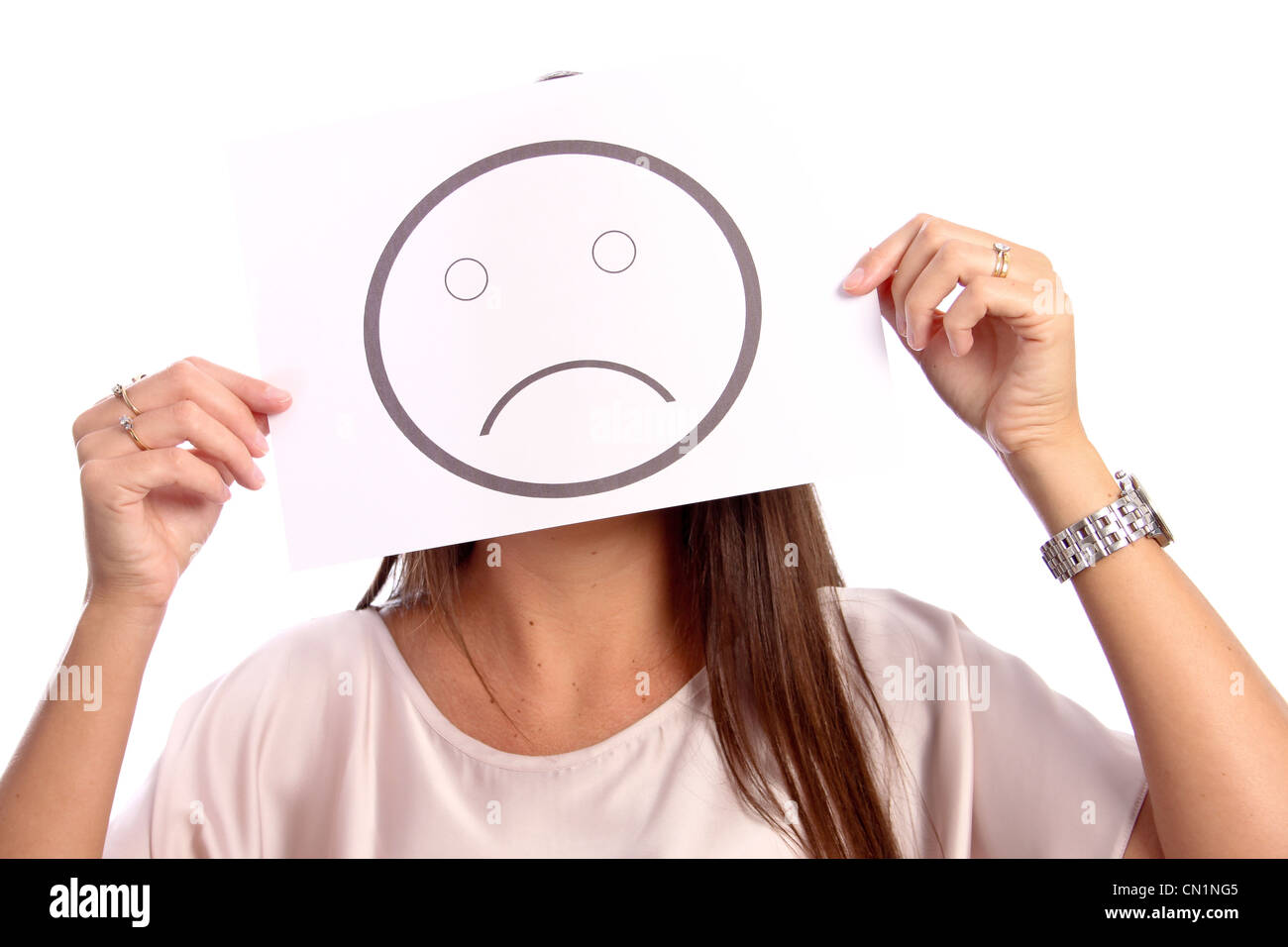 young woman holding an unhappy face drawing over her own face Stock ...