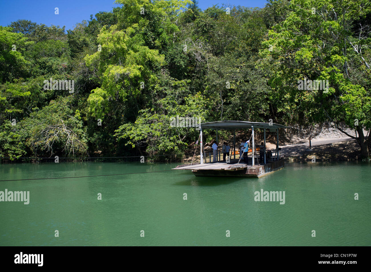A hand cranked ferry across the Mopan River in Belize leading to the ...