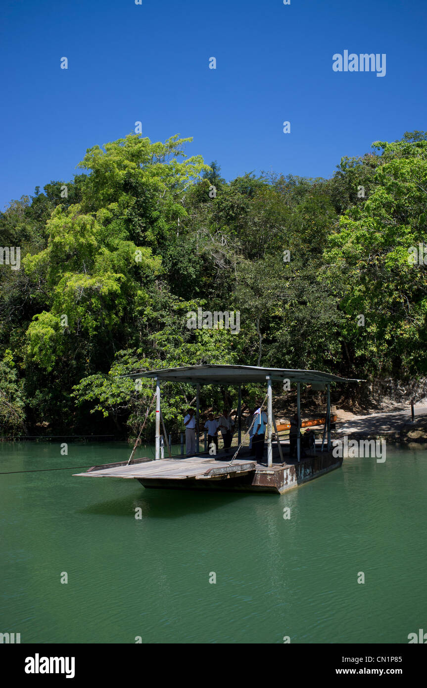 A hand cranked ferry across the Mopan River in Belize leading to the ...