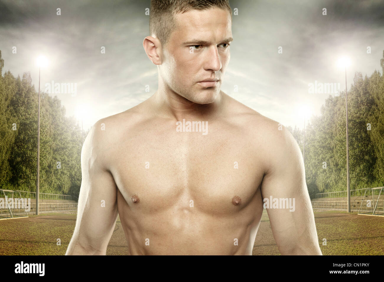 Sportsman on a field with lights Stock Photo - Alamy