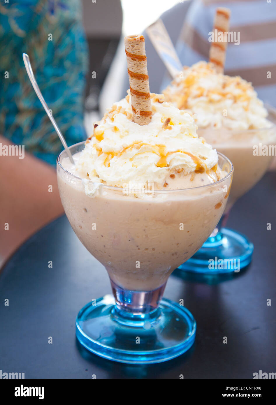 two portions of ice-cream in blue glass vases Stock Photo - Alamy