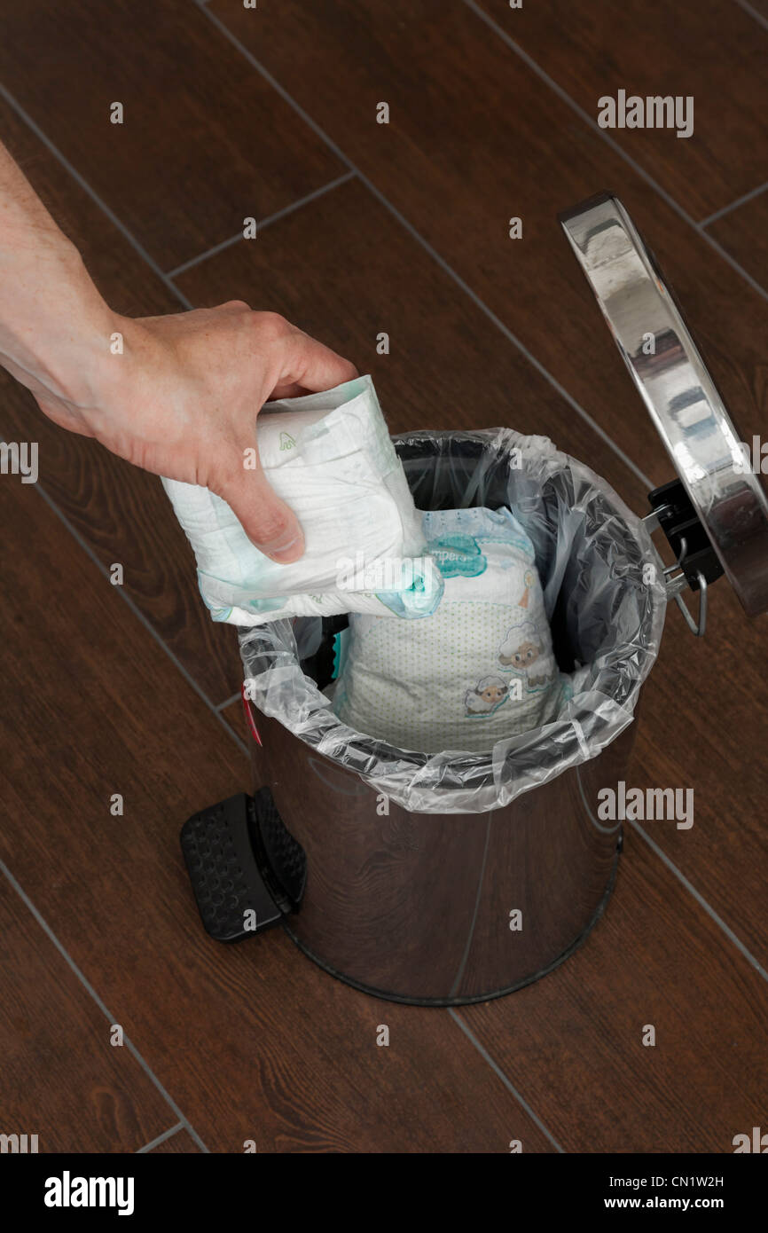 Nappy is being thrown into a dustbin Stock Photo - Alamy
