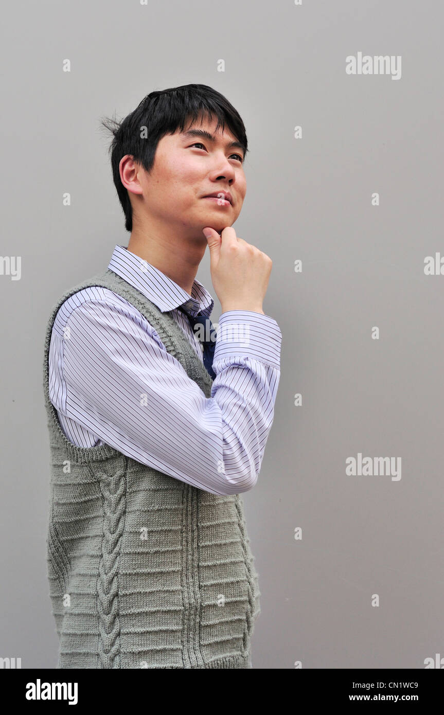 young man in thoughtful pose,fingers on chin Stock Photo - Alamy