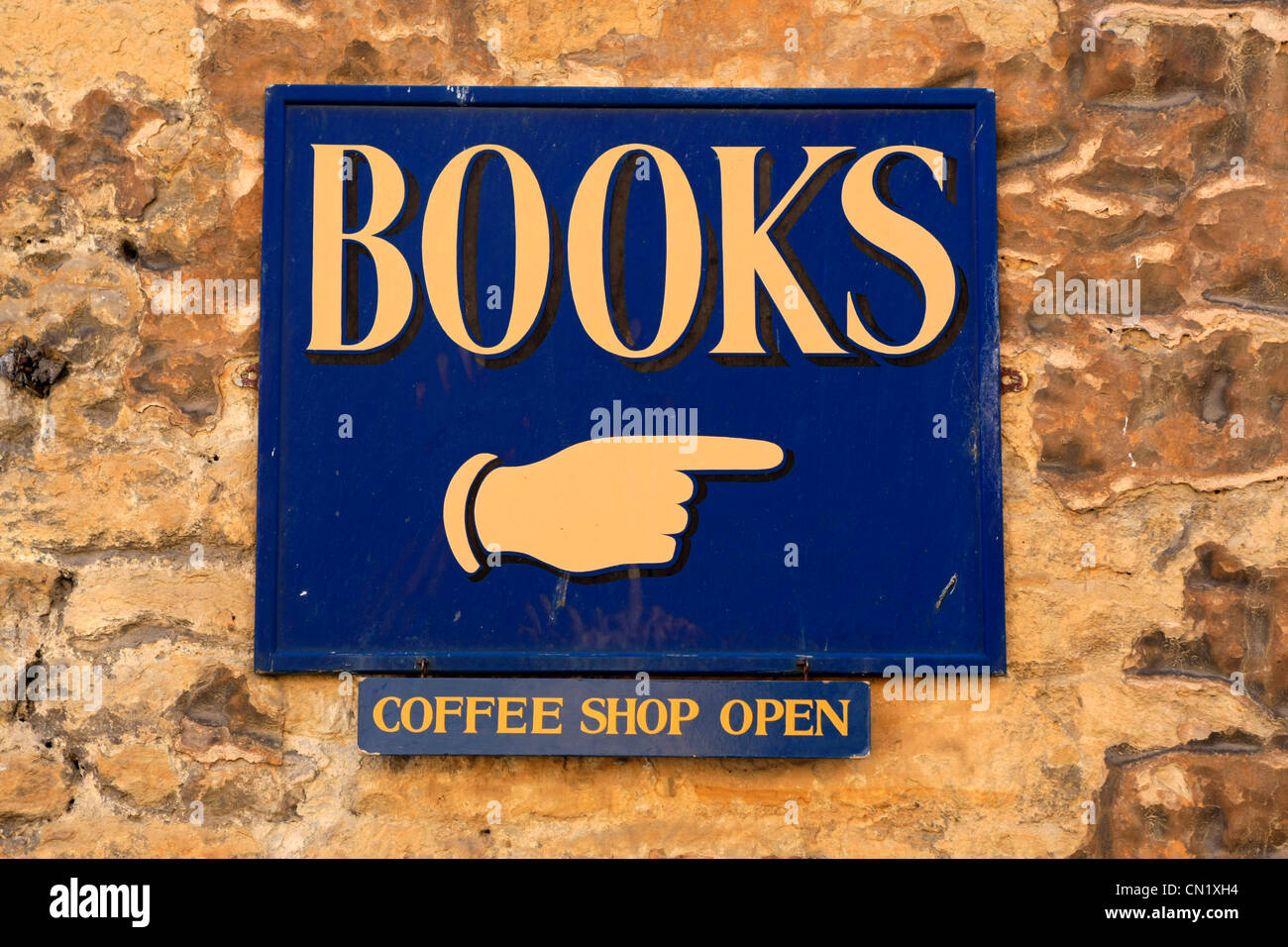 Books Sign with a hand pointing to the left Stock Photo - Alamy