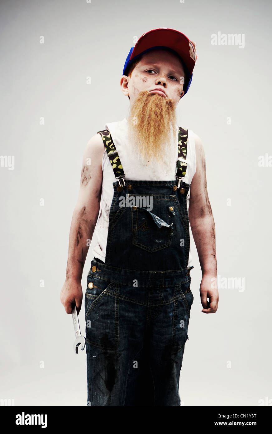 Young boy dressed up as mechanic with beard Stock Photo - Alamy