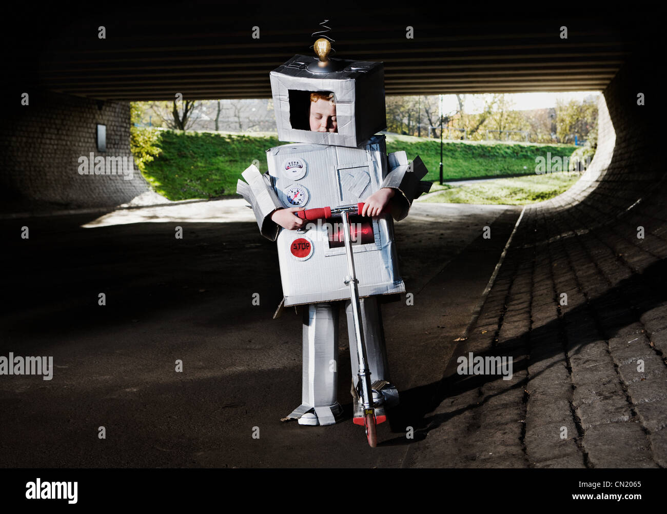 Boy dressed as robot riding scooter Stock Photo - Alamy