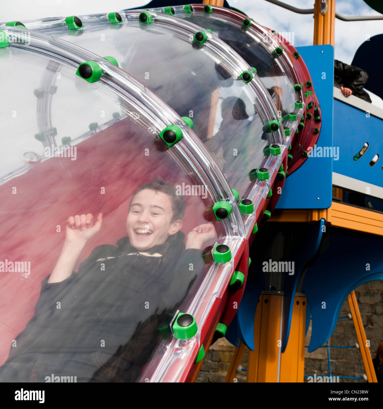 primary school children using the slide in a newly opened adventure ...