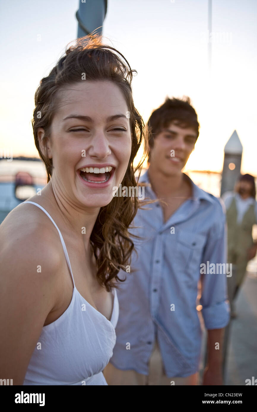 Laughing Young Woman on Boat, Portrait, With Young Man in Background ...
