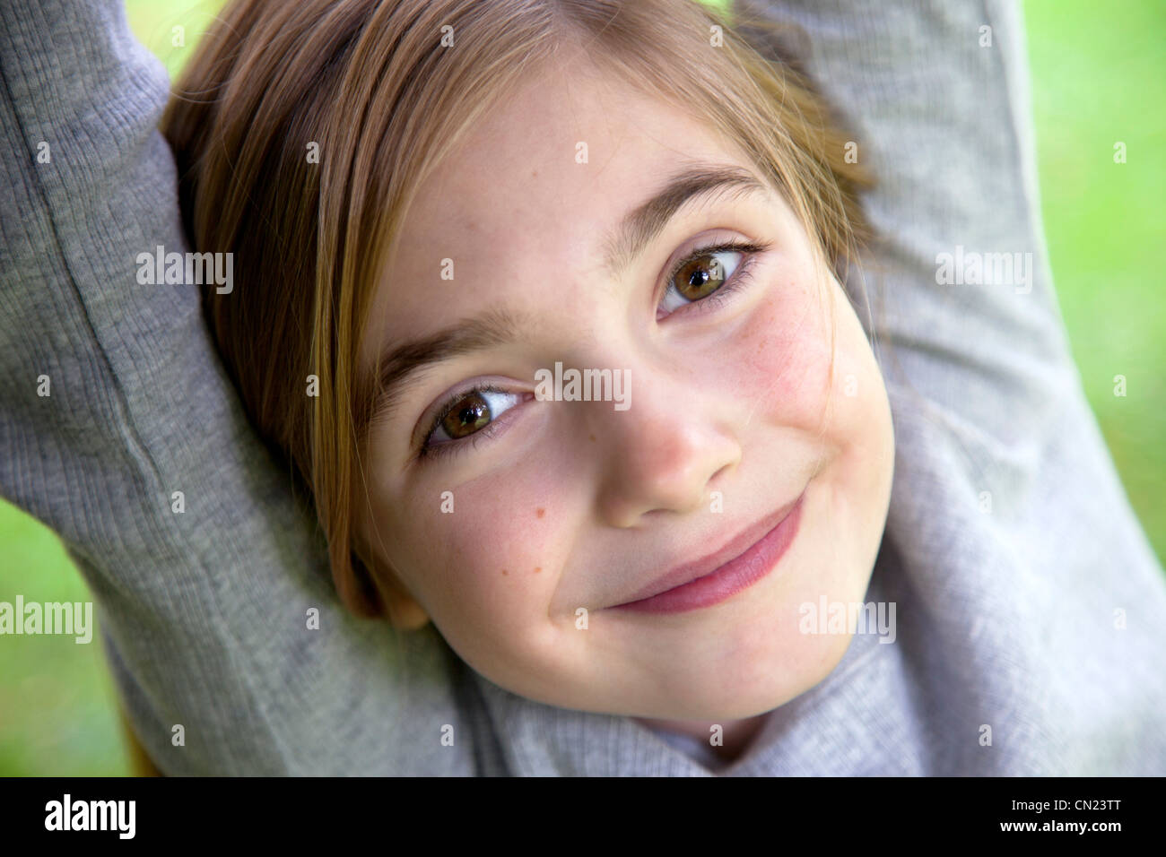 Smiling Girl With Arms Up Stock Photo - Alamy
