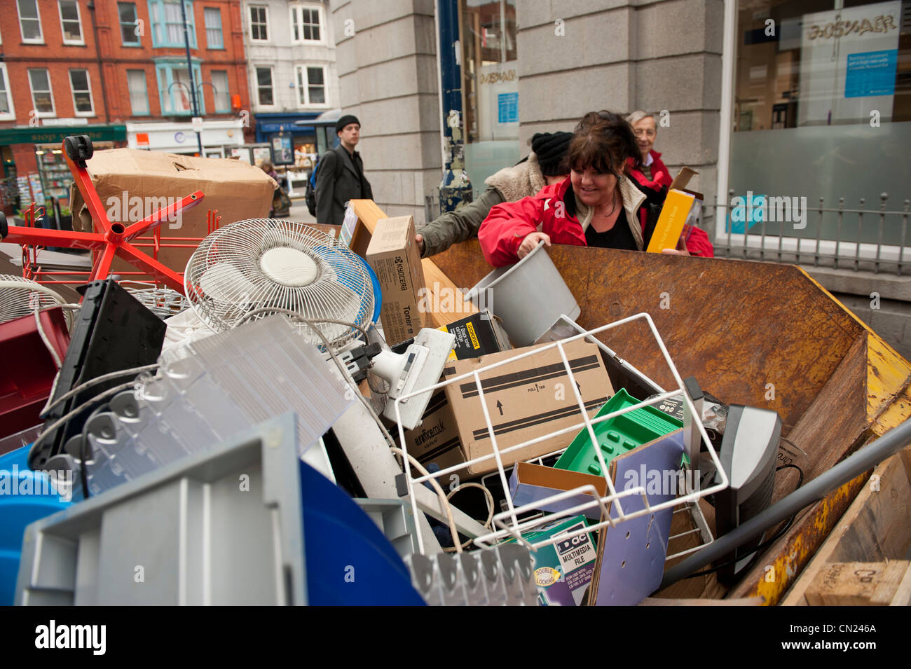 Skip raiding: People scavenging in a skip in the street for items ...