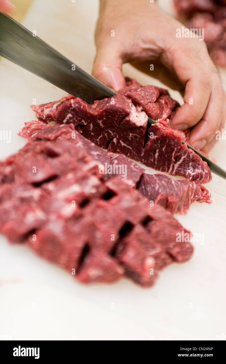 A butcher prepares slices Wagyu beef for sale at a branch of Uny ...