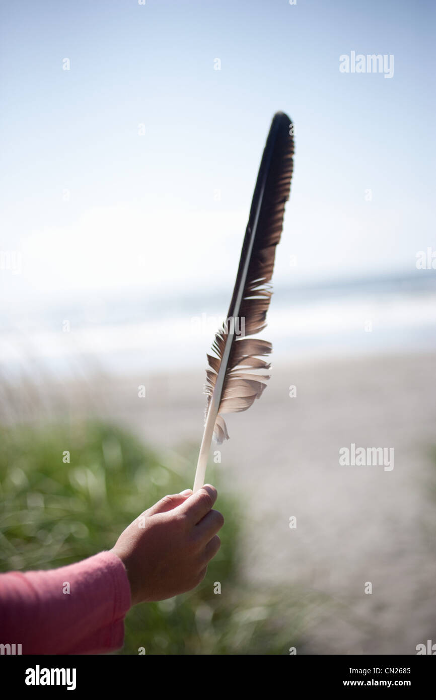Child holding a feather Stock Photo - Alamy