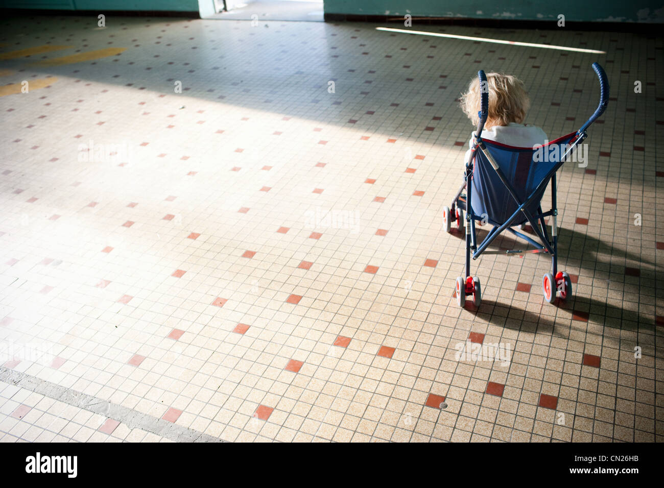 Young boy sitting in pushchair Stock Photo - Alamy