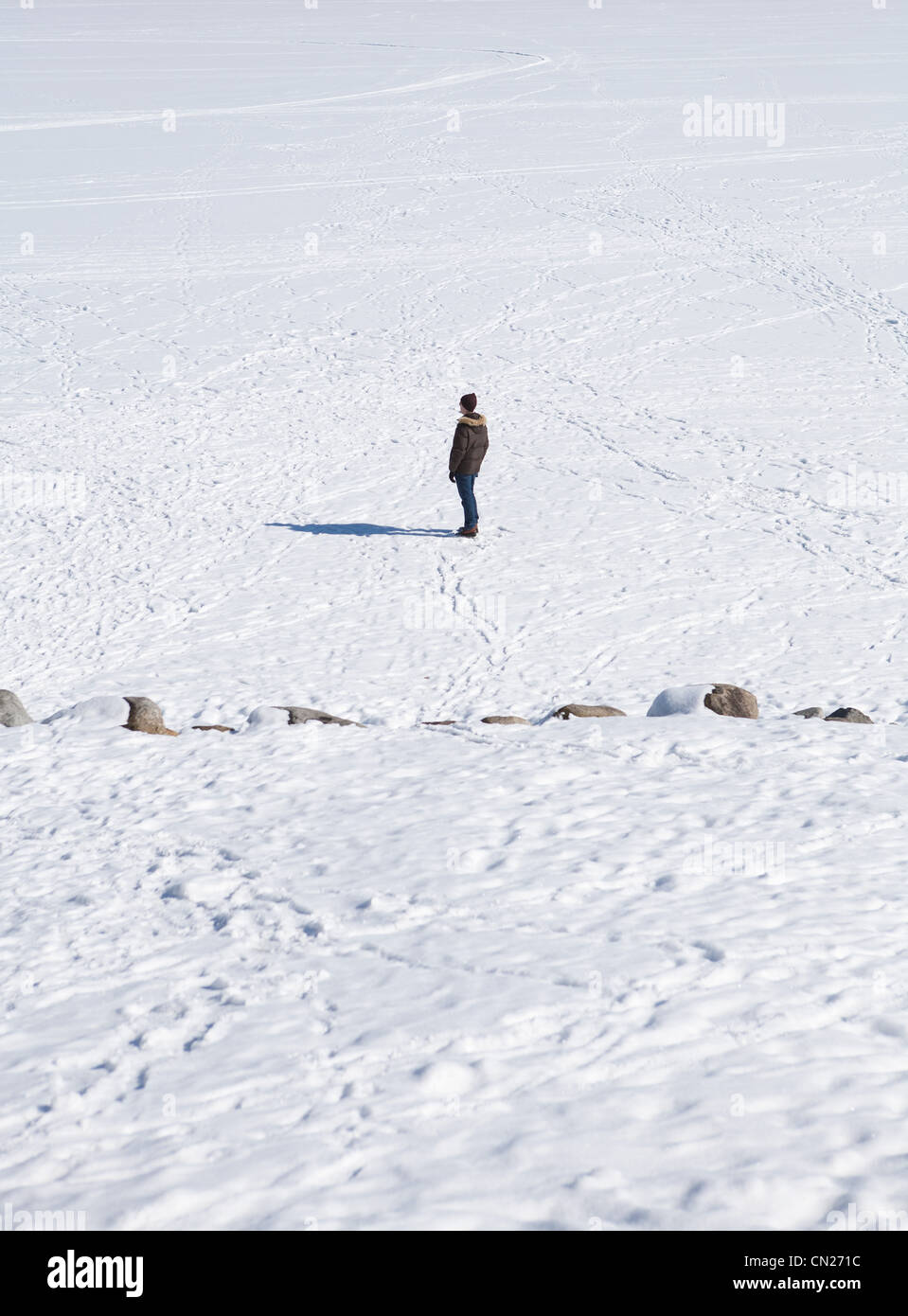 Man walking in the snow Stock Photo - Alamy