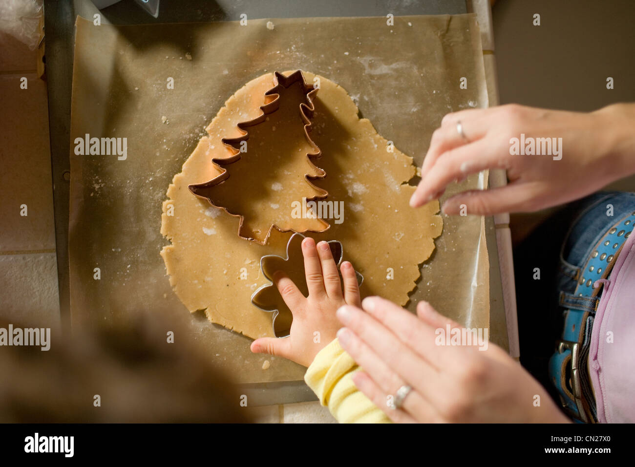 Mother and daughter cutting dough with cookie cutters Stock Photo - Alamy