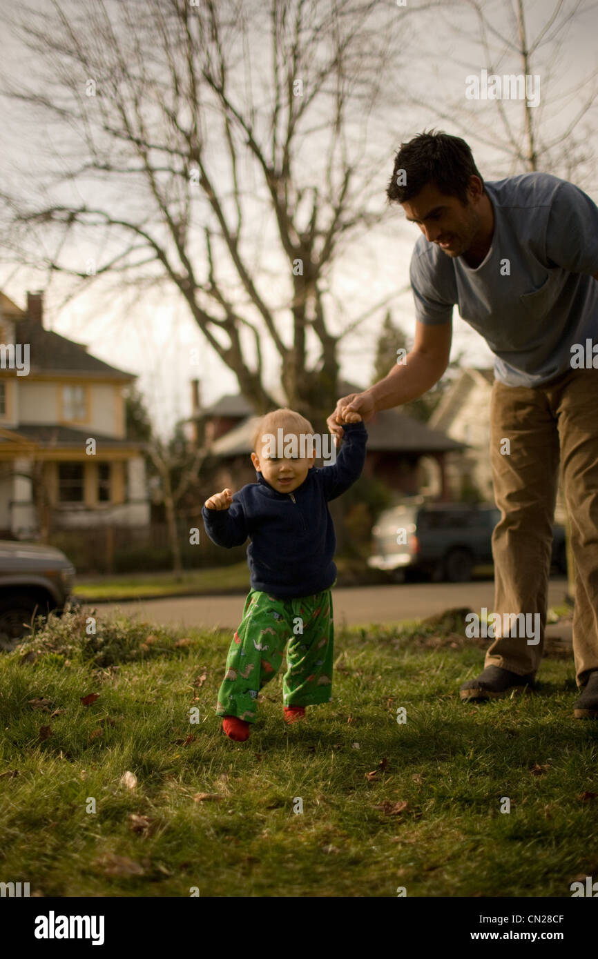 Father with son taking first steps Stock Photo - Alamy
