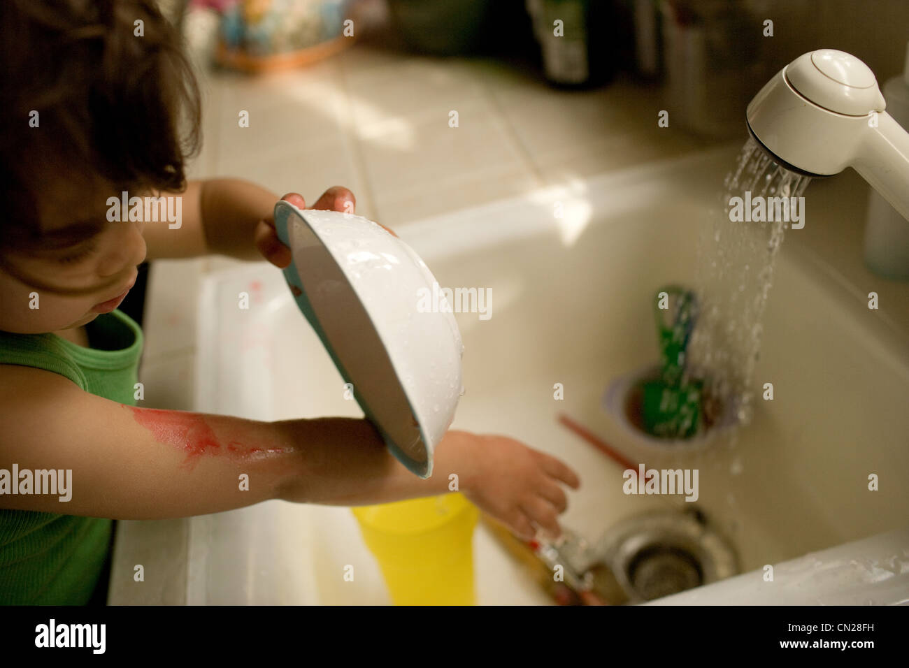 Toddler girl washing up Stock Photo - Alamy