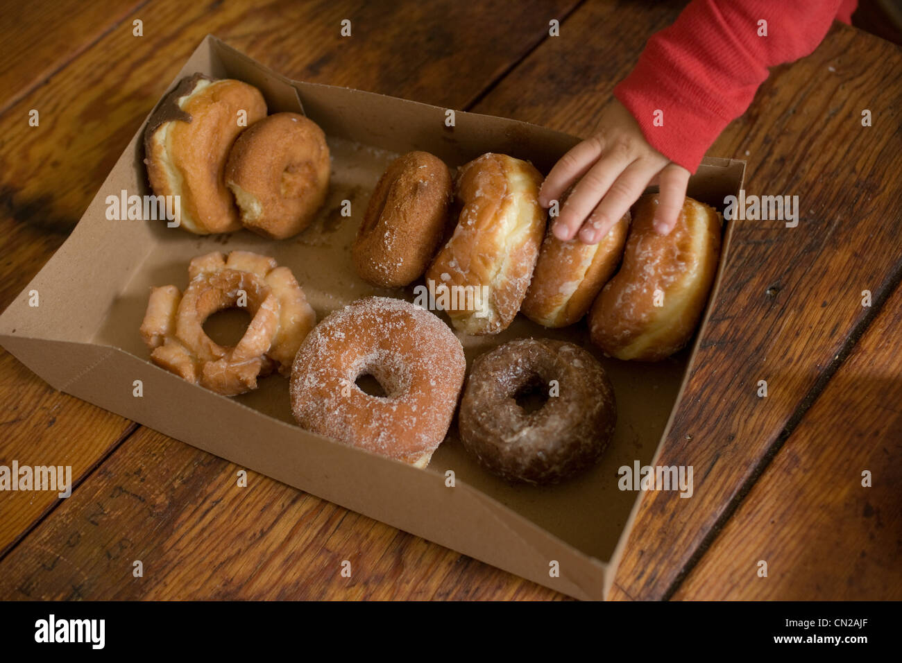 Toddler boy taking doughnut Stock Photo - Alamy