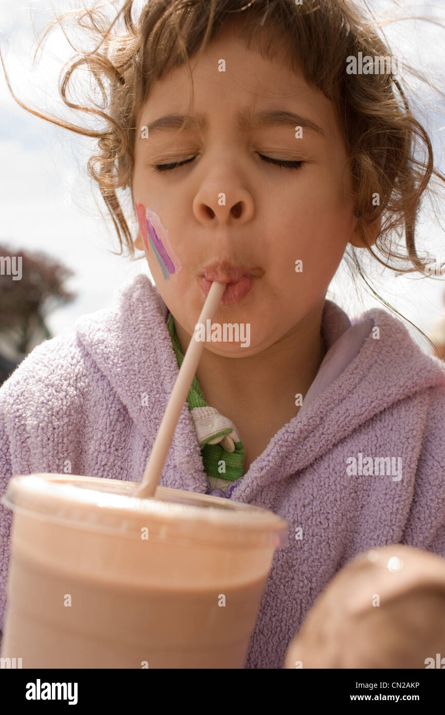 Young girl drinking milkshake Stock Photo - Alamy