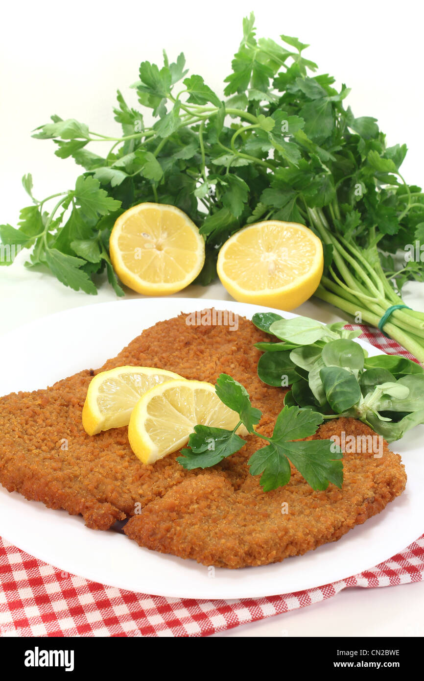 roasted wiener schnitzel with lemon slices and parsley Stock Photo - Alamy