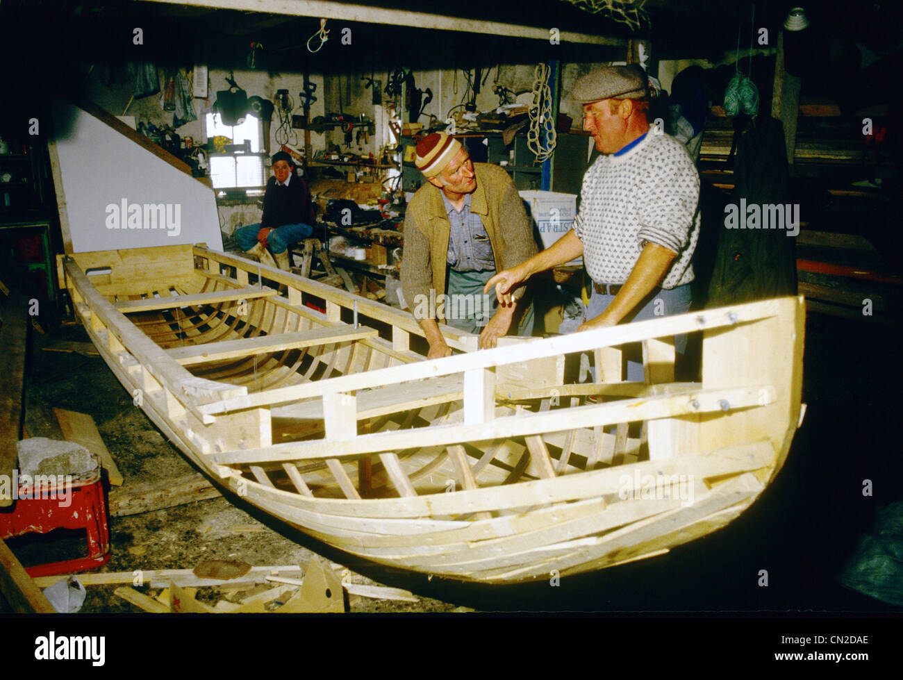 Two Aran Islanders build a traditional Currach- fishing rowing boat ...
