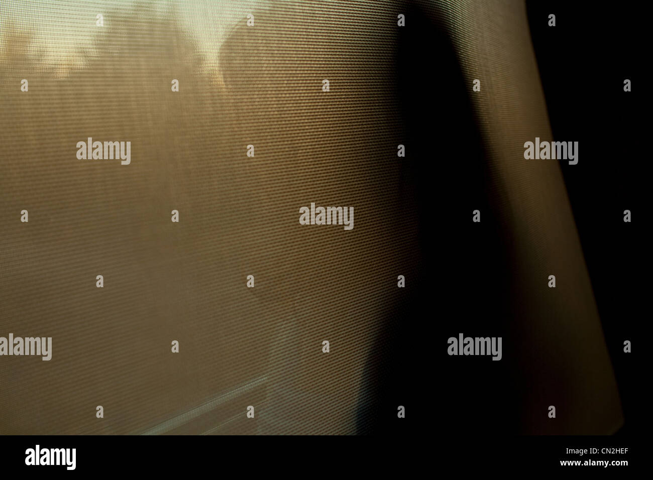 Young girl looking out of window through screen Stock Photo - Alamy