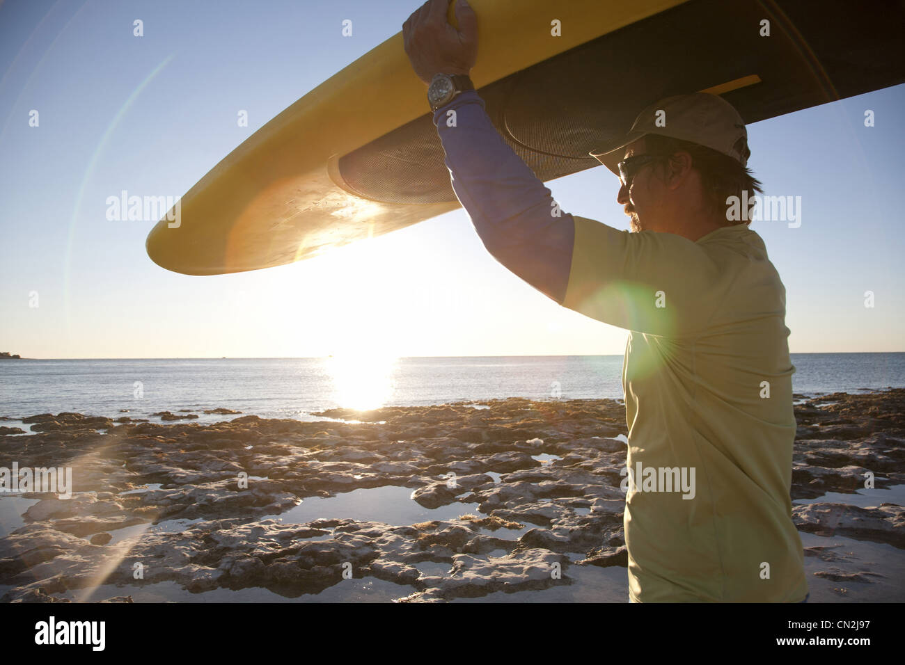 Man Carrying Paddleboard on Beach, Florida Keys, USA Stock Photo - Alamy