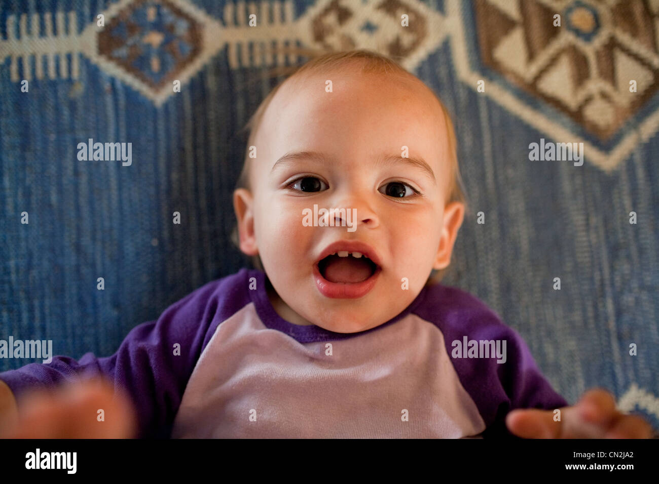 Baby boy lying on rug on floor Stock Photo - Alamy