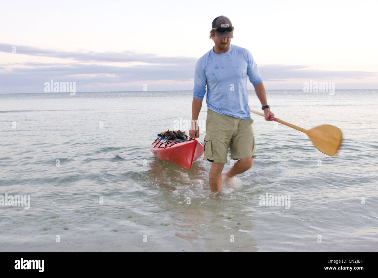 Man Pulling Kayak onto Beach, Florida Keys, USA Stock Photo - Alamy