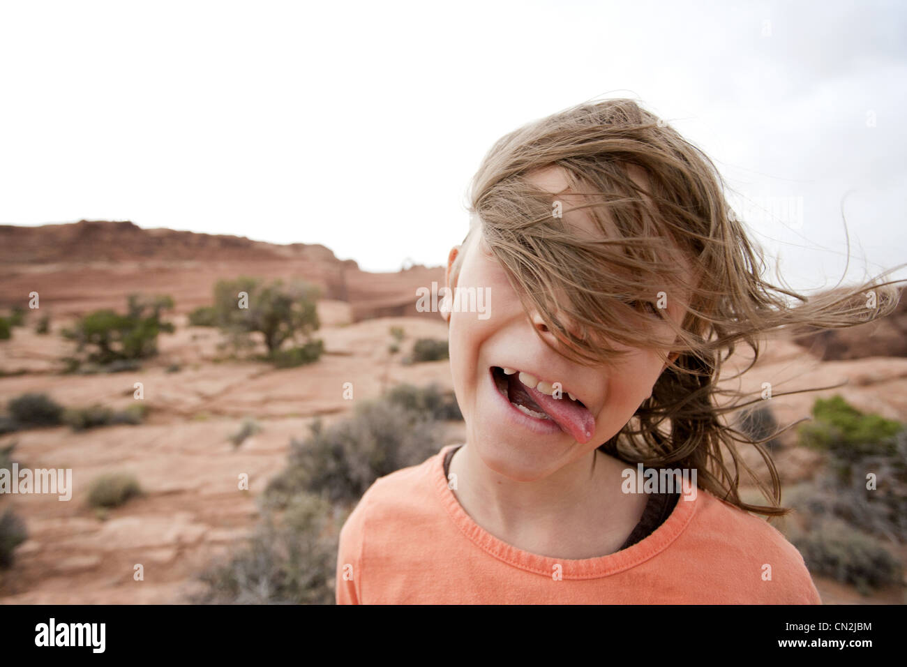 Young Girl With Silly Face and Hair Blowing in Wind Stock Photo - Alamy