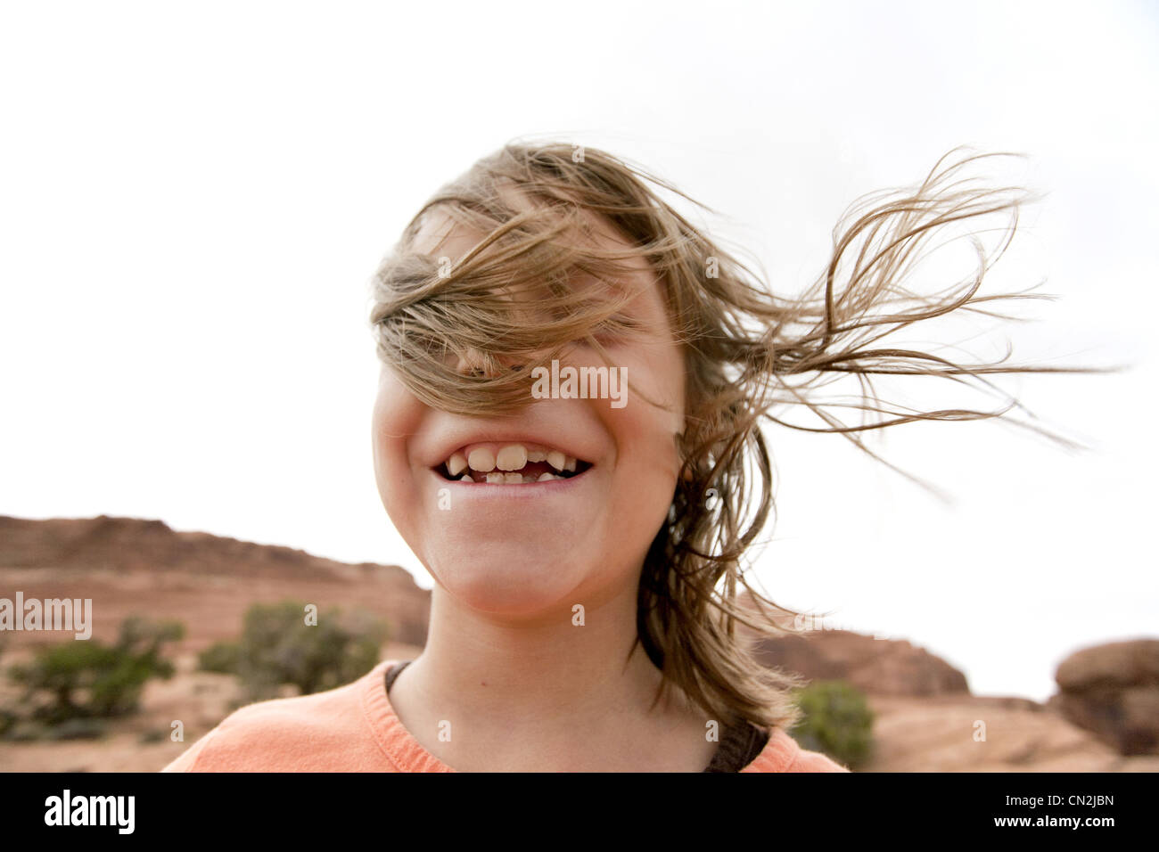 Young Girl With Silly Face and Hair Blowing in Wind Stock Photo - Alamy
