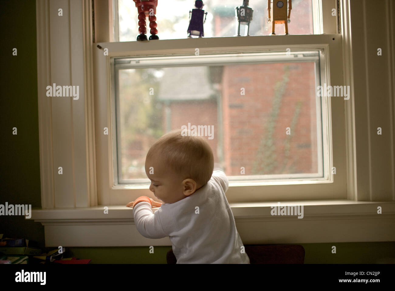 Baby boy at window Stock Photo - Alamy