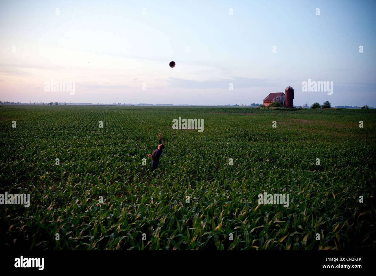 Farmer throwing hat in the air in field Stock Photo - Alamy