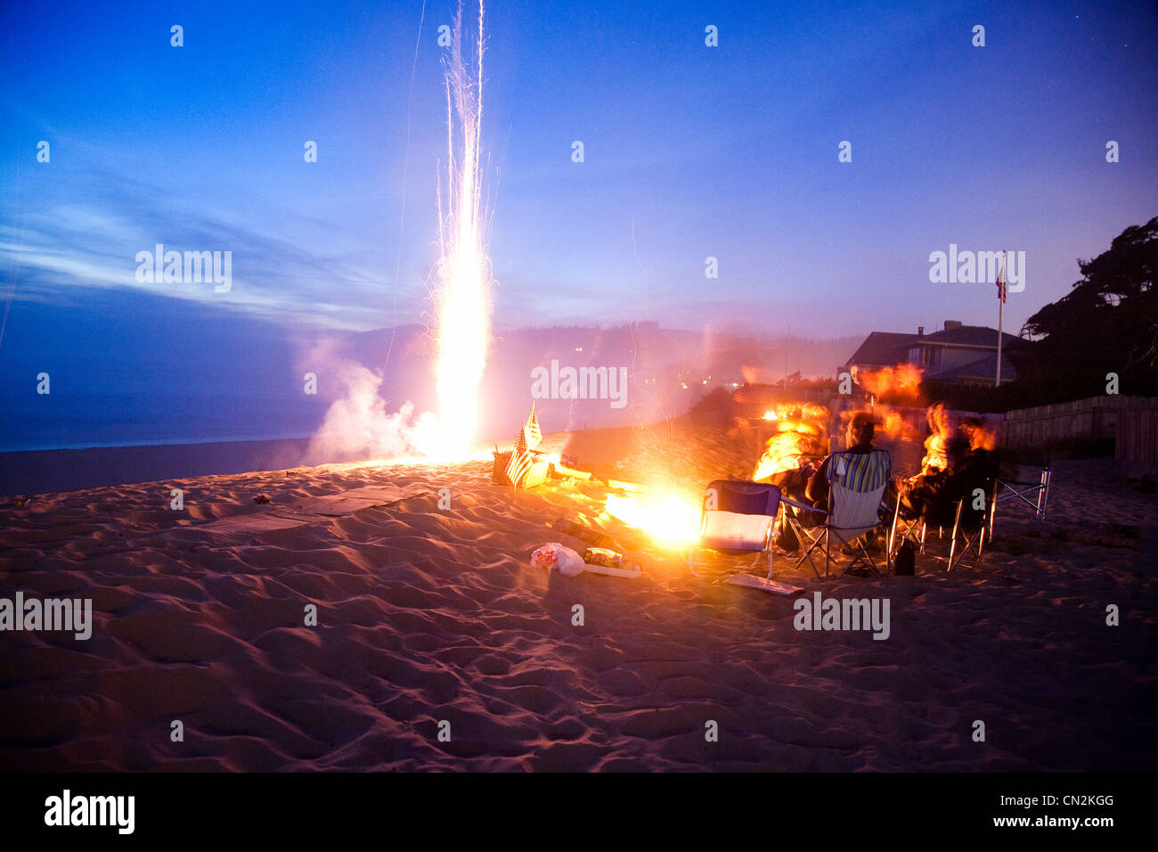People on beach with bonfire and fireworks at night Stock Photo - Alamy