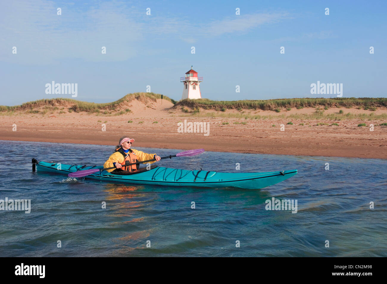 Kayaker explores sandy beach & Atlantic Ocean shoreline along PEI ...