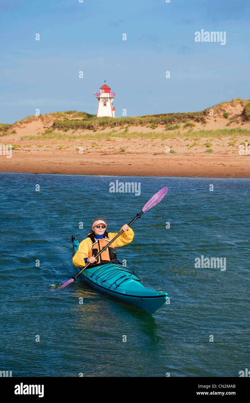 Kayaker explores sandy beach & Atlantic Ocean shoreline along PEI ...
