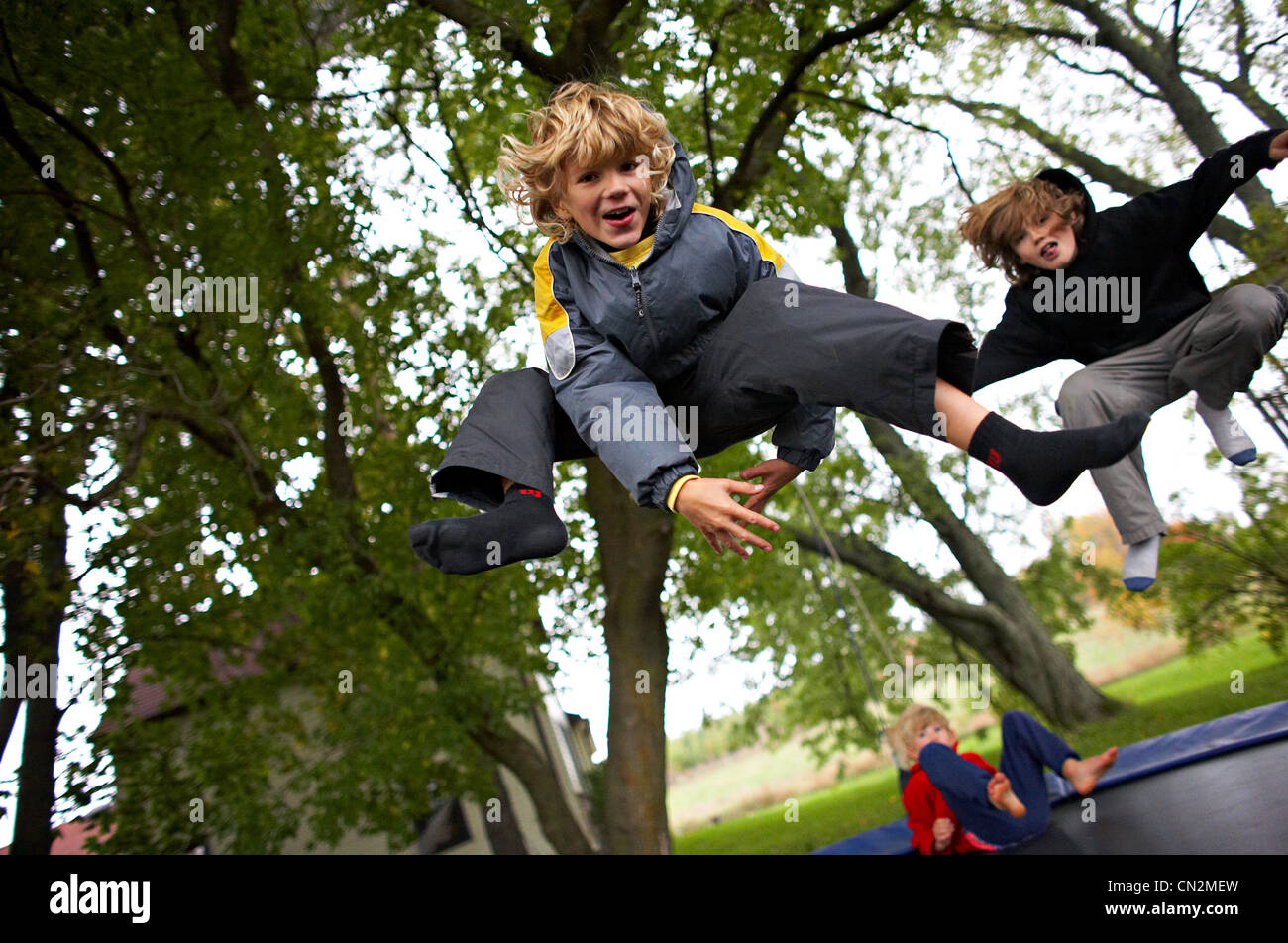 Boys Jumping on Trampoline Stock Photo - Alamy