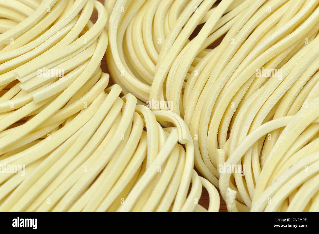 Raw chinese noddle background Stock Photo - Alamy