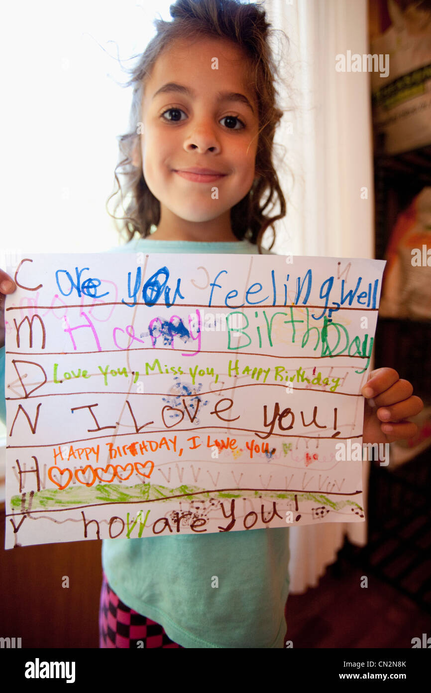 Girl holding piece of paper with handwriting Stock Photo - Alamy
